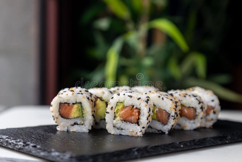 Closeup of Asian Sushi Rolls on Black Kitchen Board Stock Image - Image ...