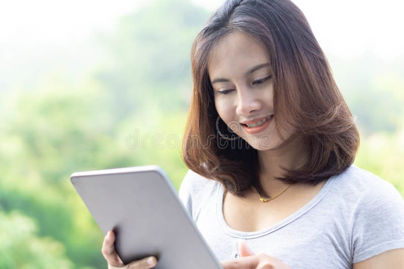 Closeup Asian Woman Using Digital Tablet with Green Nature Background ...