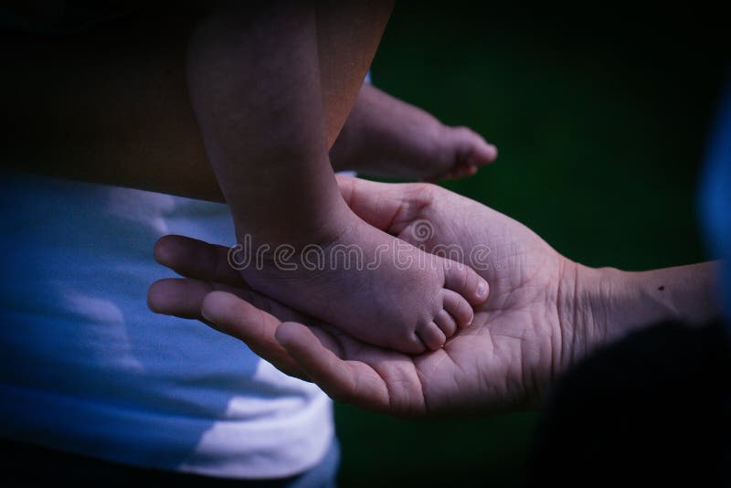 Closeup of Baby Foot in a Hand Stock Image - Image of childhood, hand ...