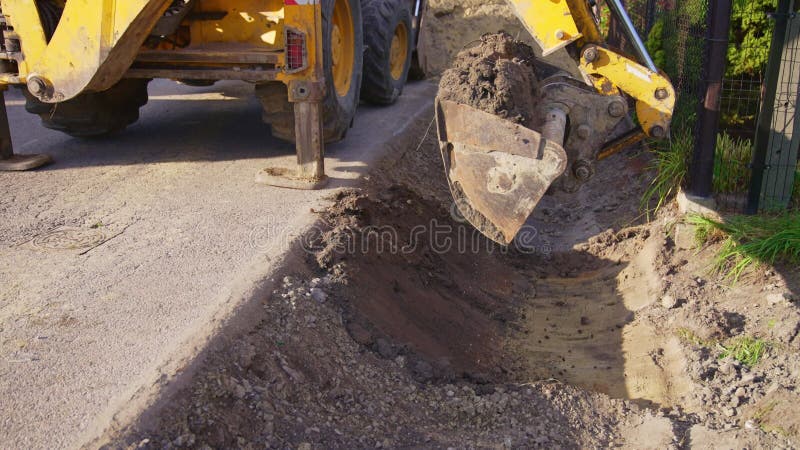 Closeup of a Backhoe Loader Equipment Picking Scraps and Soil from ...