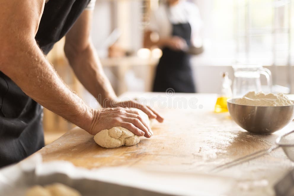 Closeup of Baker Hands Kneading Raw Dough on Kitchen Table in Bakery ...
