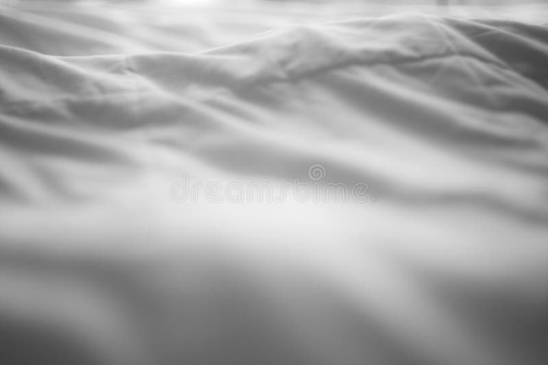 Closeup of Beautiful White Shiny Crumpled Fabric Sheets on the Bed ...