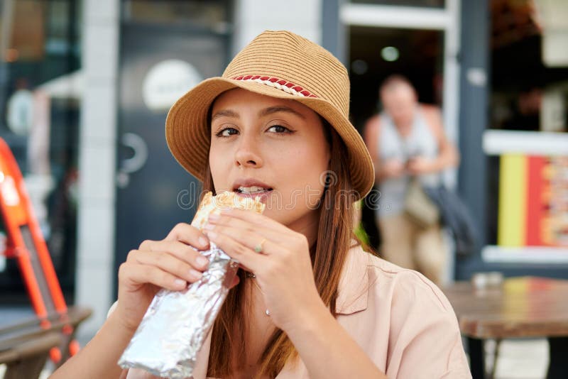 Closeup of a Beautiful Young Female Eating a Wrap Outdoors Stock Image ...