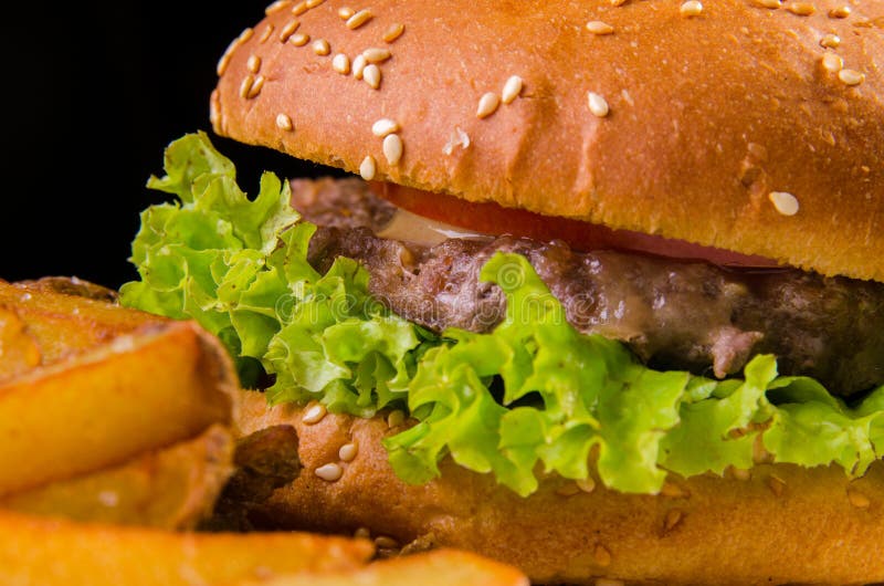 Closeup Beef Burger with Lettuce Leaves and Sesame Seeds Stock Photo ...