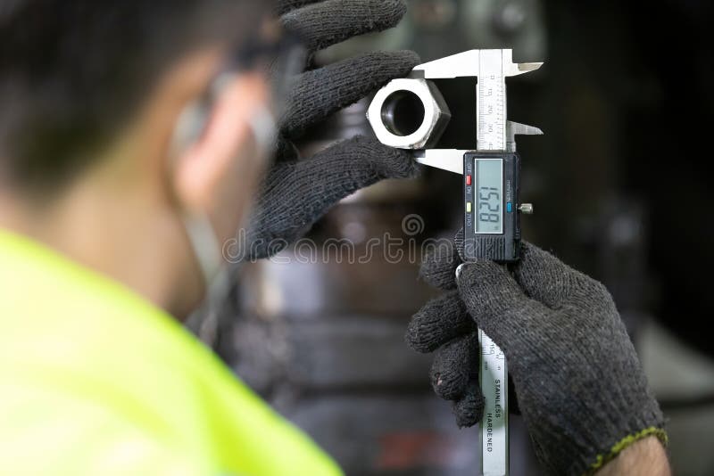 Engineer Man or Factory Worker Using Calipers Measures the External ...