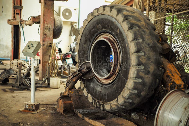 Closeup Big Tyre of Truck Under Maintenance on the Machine in the ...