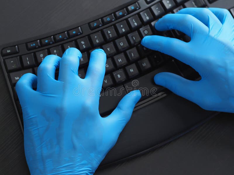 Closeup of Black Computer Keyboard and Hands in Blue Latex Gloves ...