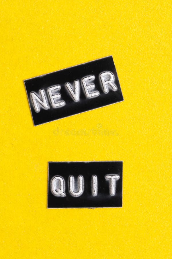 Closeup Black Letters on Yellow Background with Words Never Quit. Stock ...