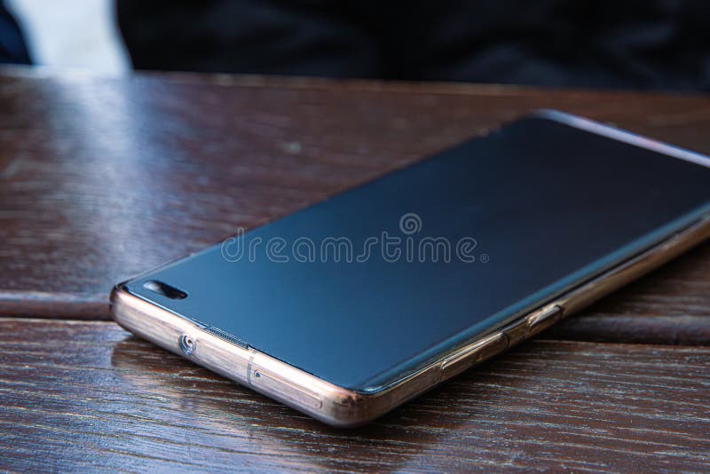 Closeup of the Black Screen Smartphone on a Dark Brown Wooden Cafe ...