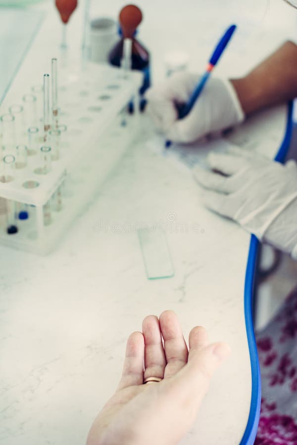 Closeup of Blood Sampling from Finger, Lab Technician and Patient Hands ...