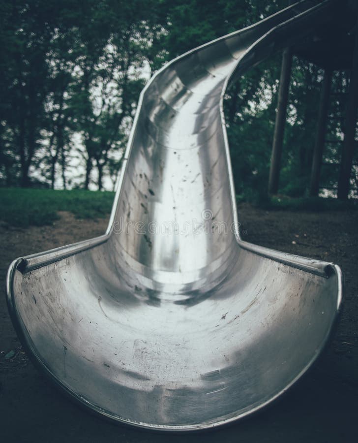 Closeup of the Bottom of a Long Metal Slide at a Playground Stock Photo ...
