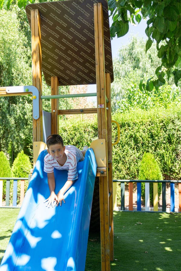 Closeup of a Boy Sliding on an Outdoor Playground Slide Stock Photo ...