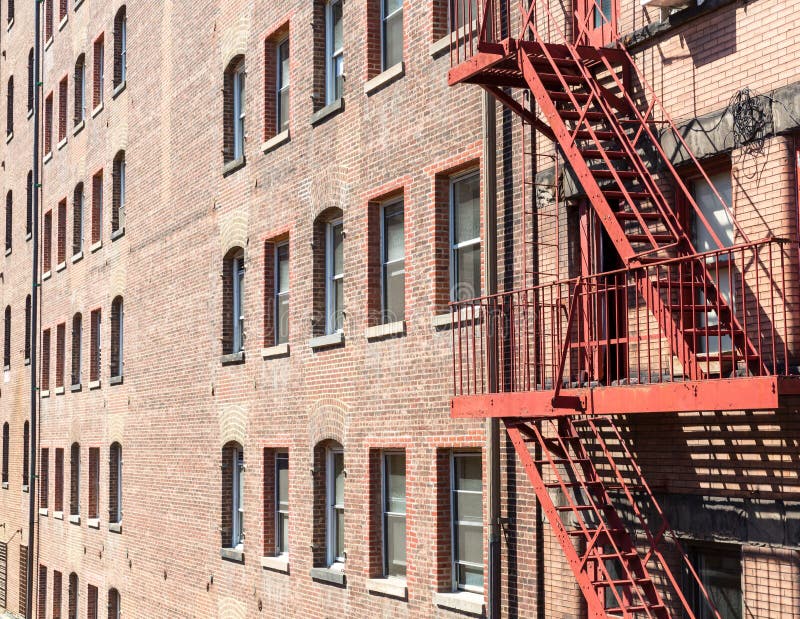 Closeup of Brick Building with Fire Ladders. Stock Image - Image of ...
