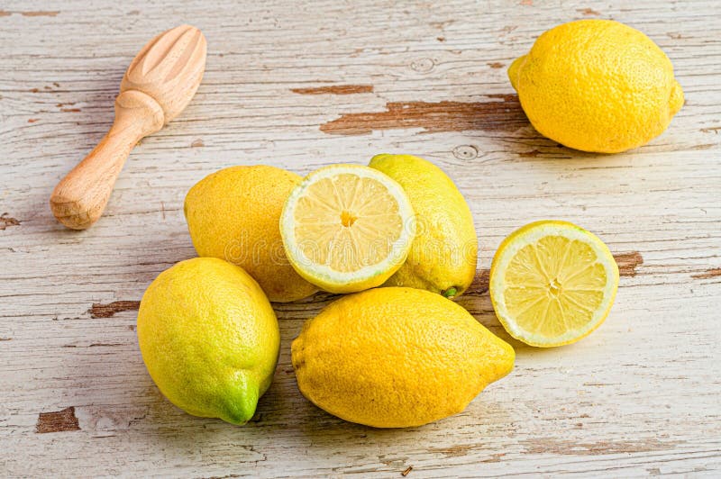 Closeup of Bright Yellow Lemons on a Wooden Surface Under the Natural ...
