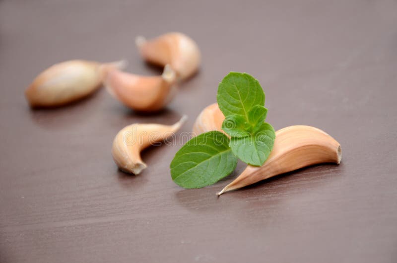 Closeup the Bunch Brown Garlic with Green Mint Over Out of Focus Brown ...