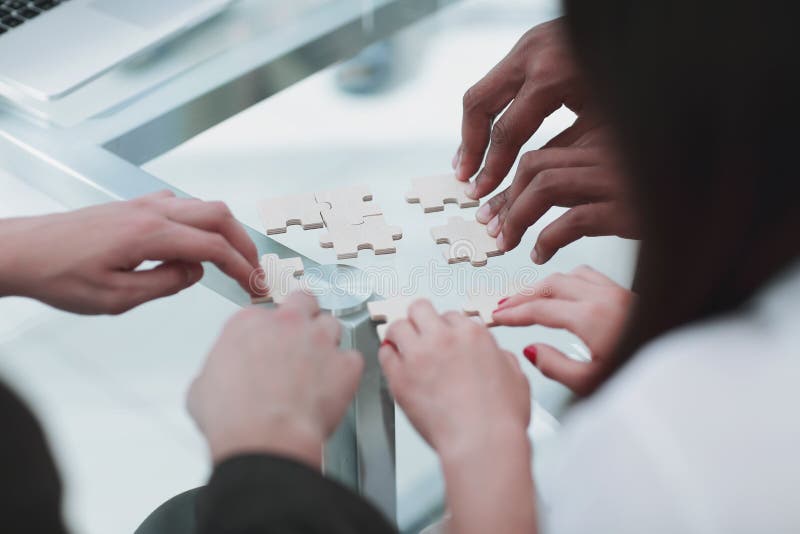 Close Up. Business Team Assembling Puzzle Pieces. Stock Image - Image ... Close Up. Business Team Assembling Puzzle Pieces. Stock Image - Image ...