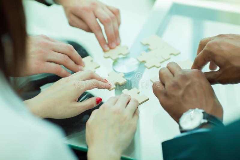 Close Up. Business Team Assembling Puzzle Pieces. Stock Image - Image ... Close Up. Business Team Assembling Puzzle Pieces. Stock Image - Image ...