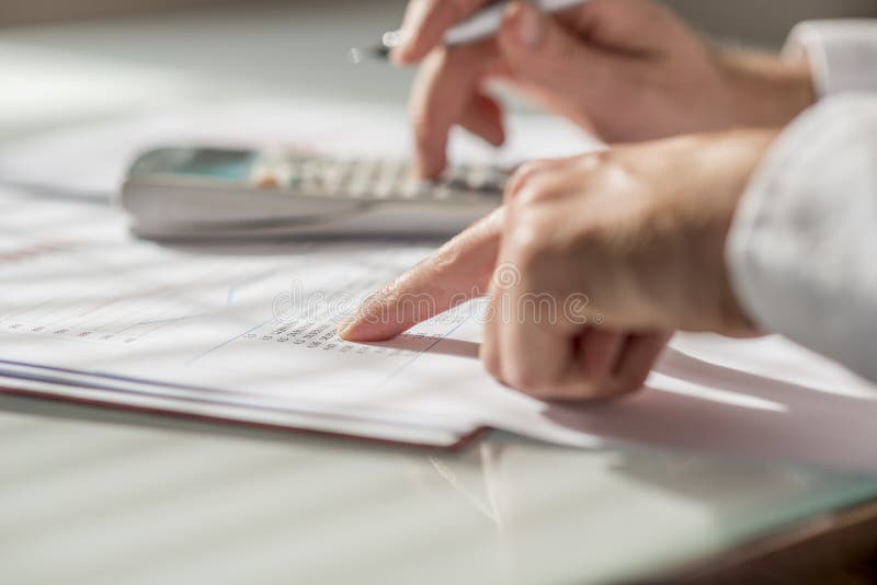 Businessman Accountant Using Calculator and Filling Report Near Laptop ...