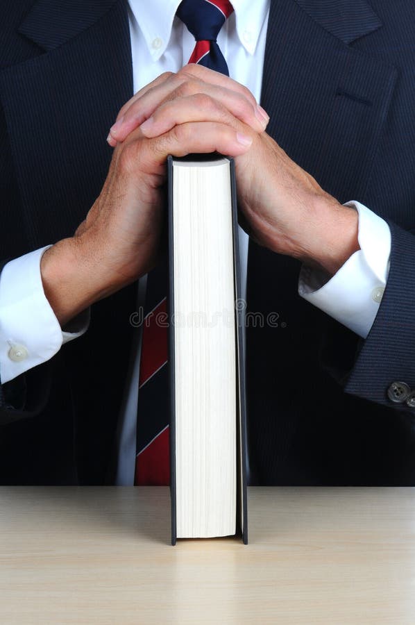 Closeup of a Businessman Leaning on Book at Desk Stock Image - Image of ...