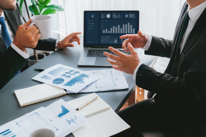 Closeup Busy Analyst Team with Coffee Discuss Financial Data on Laptop ...