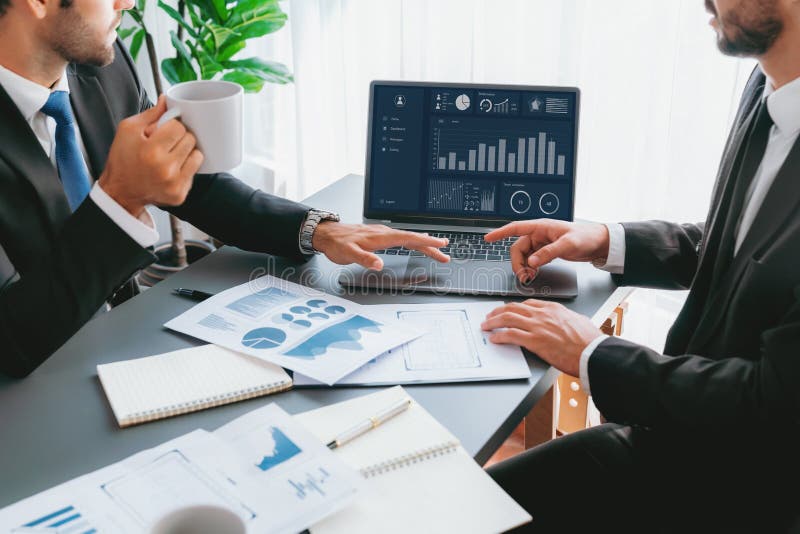 Closeup Busy Analyst Team with Coffee Discuss Financial Data on Laptop ...