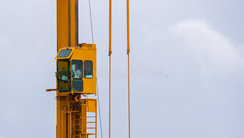 Closeup of the Cabin with a Man Operating a Crane, Construction Site ...