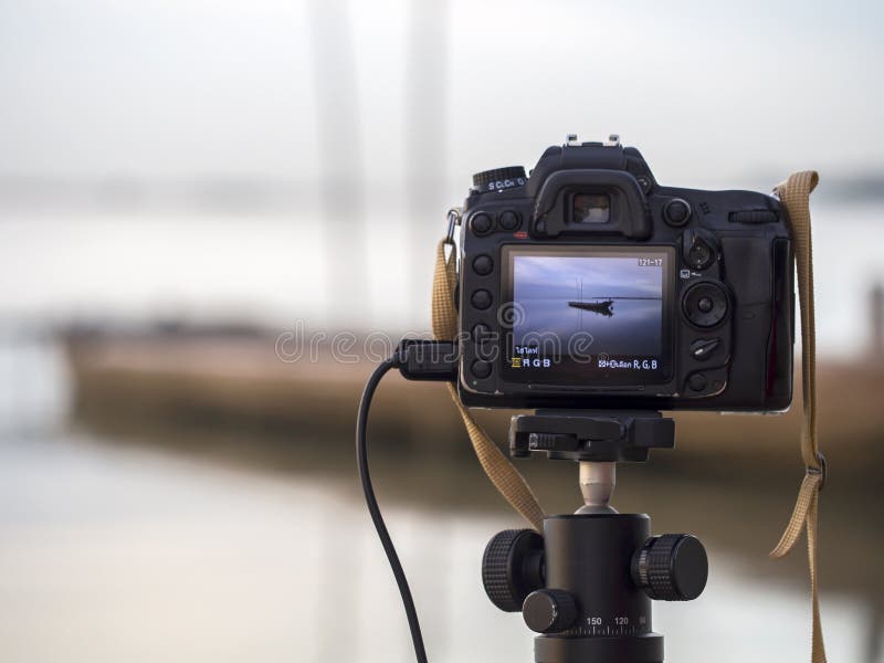 Closeup of a Camera on a Tripod Outdoors. Background Landscape Out of ...