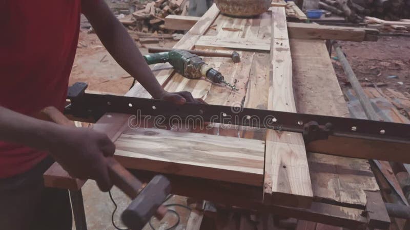 Closeup of a Carpenter Hands Working on Wooden Planks with Tools on a ...