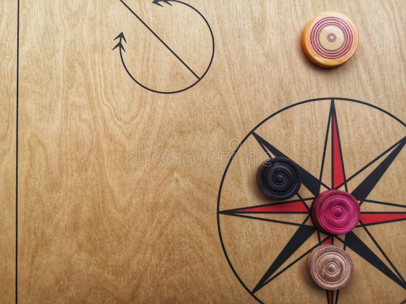 Closeup a Carrom Striker and Carrom Men Balls on the Carrom Board. Play ...