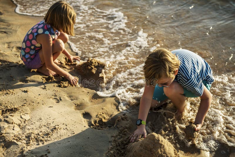Closeup of Caucasian Kids Playing with the Sand Together at the Stock ...