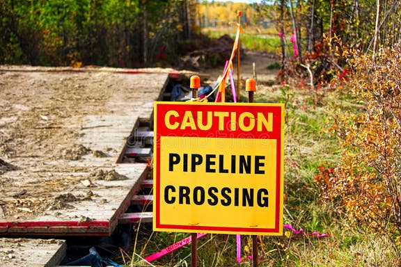 Closeup of a Caution Pipeline Crossing Sign Stock Photo - Image of ...