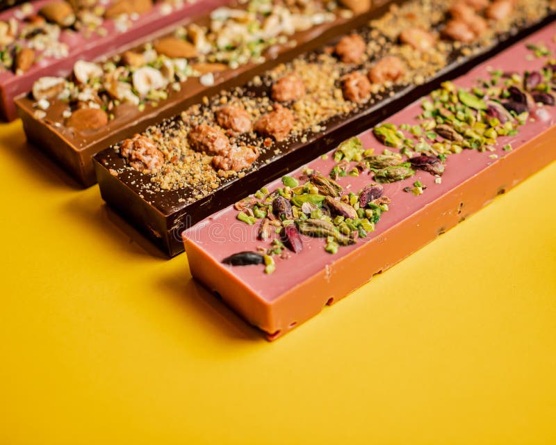 Closeup of Chocolate Assortment Bars with Different Flavors on a Yellow ...