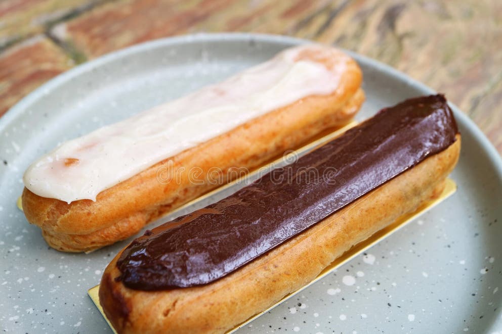 Chocolate Eclair with Blurry Vanilla Eclair in the Backdrop Stock Photo ...