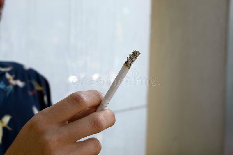 Closeup Cigarette in the Hand of Someone Smoking Stock Image - Image of ...