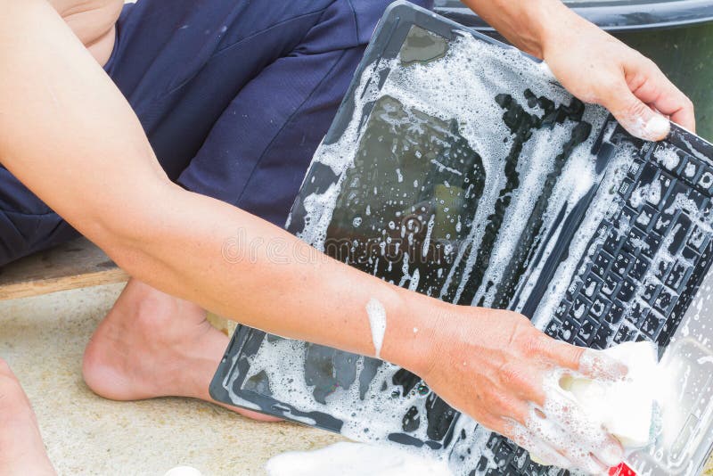 Closeup Cleaning Computer Notebook with Dish Washing Soap, Technology ...