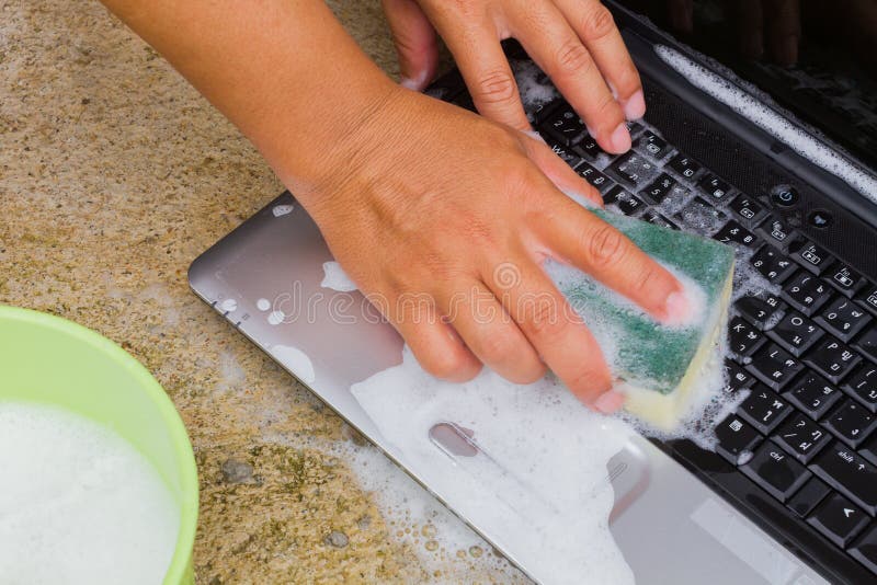 Closeup Cleaning Computer Notebook with Dish Washing Soap, Technology ...