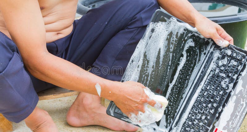 Closeup Cleaning Computer Notebook with Dish Washing Soap, Technology ...