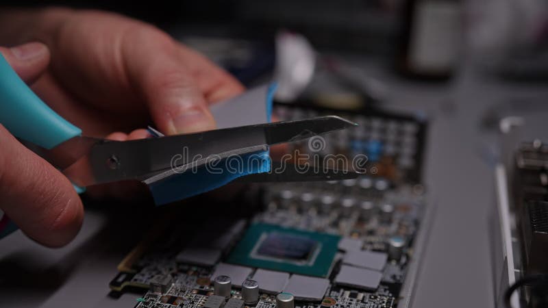 Closeup of Computer Technician Malr Cutting Thermal Pad with Scissors ...