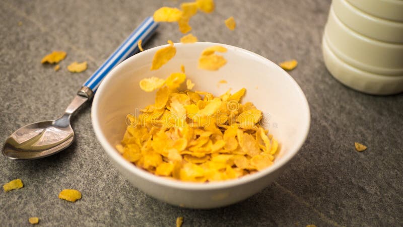 Closeup of Corn Flakes Falling in a White Bowl Isolated on White ...