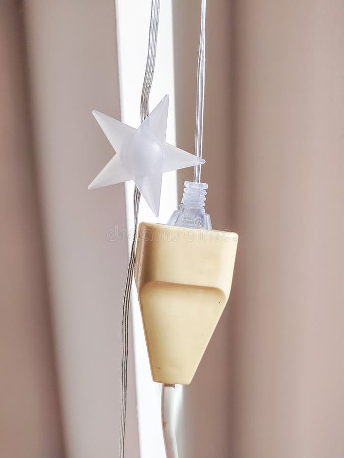 Closeup of a Creamcolored Electrical Plug with a String of Lights ...