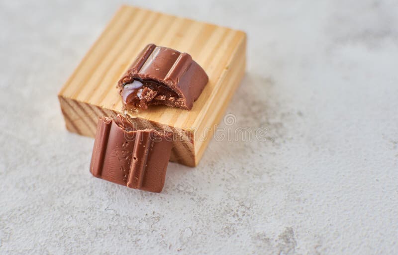 Closeup of a Cut Stuffed Chocolate Candy on a Wooden Surface Stock ...