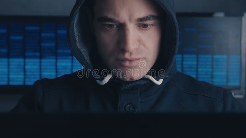 Male Hacker Programmer Working at Computer while Blue Code Characters ... Male Hacker Programmer Working at Computer while Blue Code Characters ...