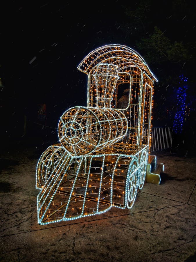 Closeup of a Decorated Train with Christmas Lights in a Dark Garden ...