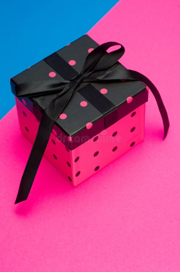 Closeup Details of a Pink and Black Gift Box on a Blue and Pink ...