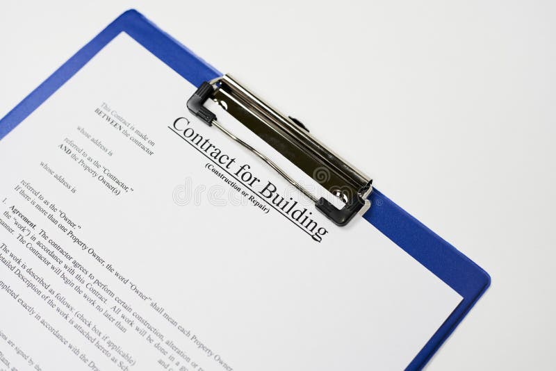 Closeup of a Document Entitled Contract for Building on a Blue ...