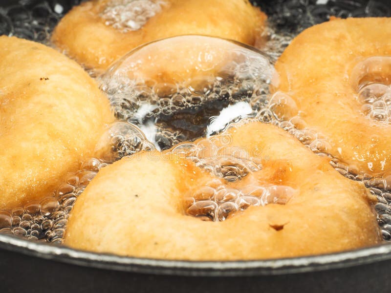 Closeup of Donuts Cooking in Boiling Oil Stock Photo - Image of ...