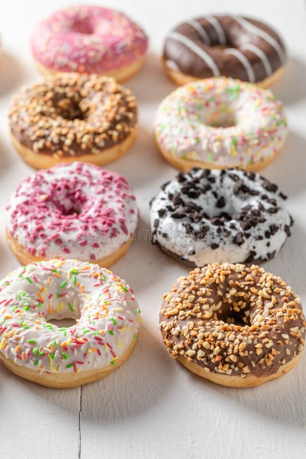 Donuts with Toppings on White Table Stock Photo - Image of glaze, icing ...