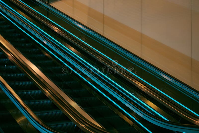 Closeup of the Empty Escalators at Night with Neon Blue Lights on the ...