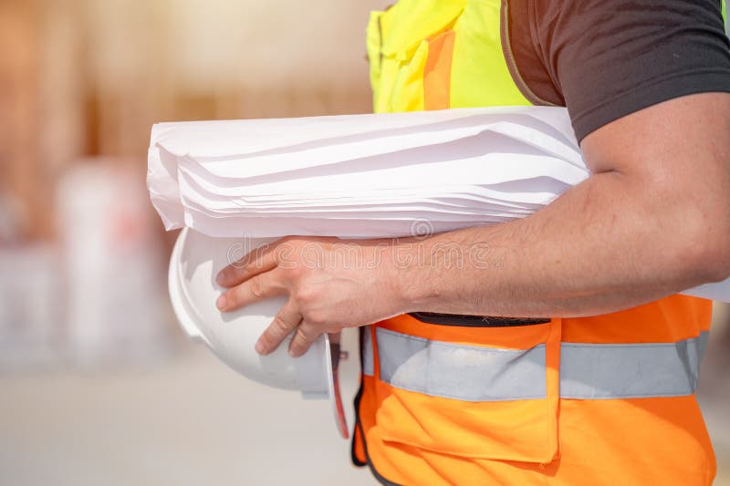 Closeup Engineer Construction Workers with Blueprint and Safety Hard ...