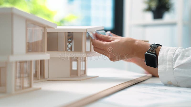 Closeup of Engineer Hand Measure House Model and Write on Blueprint ...